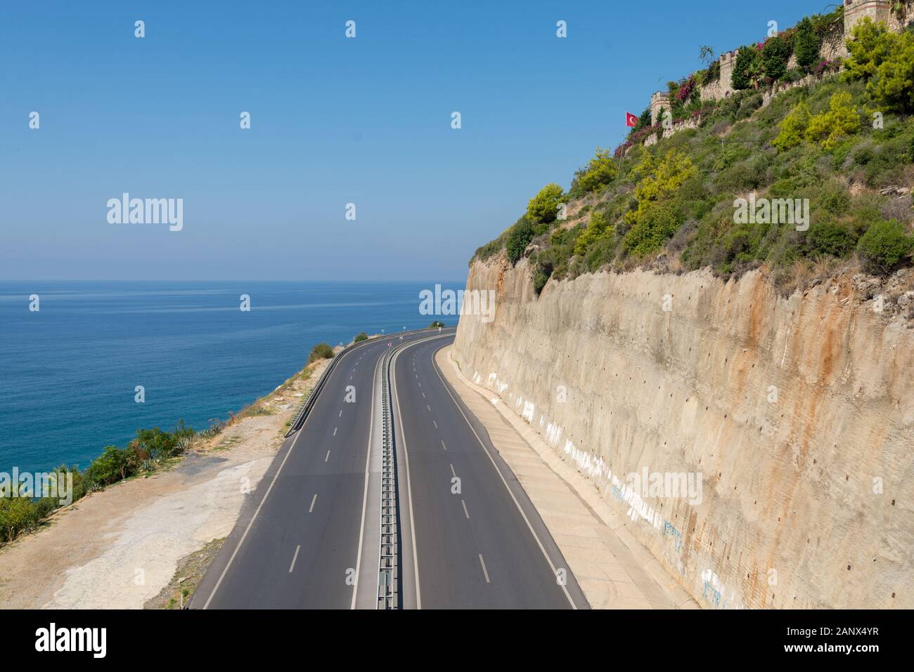 Turkish coastal highway along the sea below the steep cliff Stock Photo ...