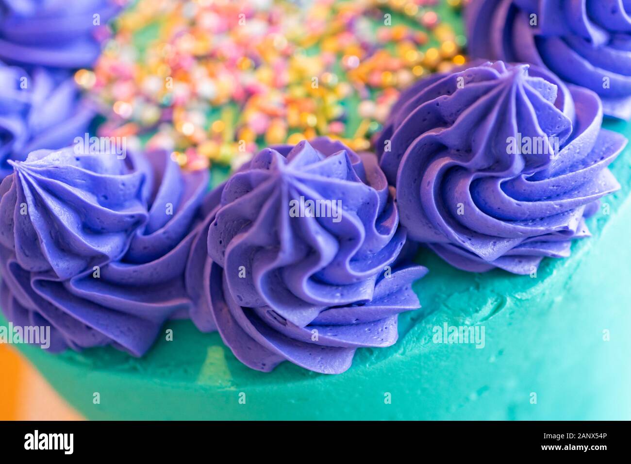 Birthday cake with turquoise buttercream and purple rosettes and ...