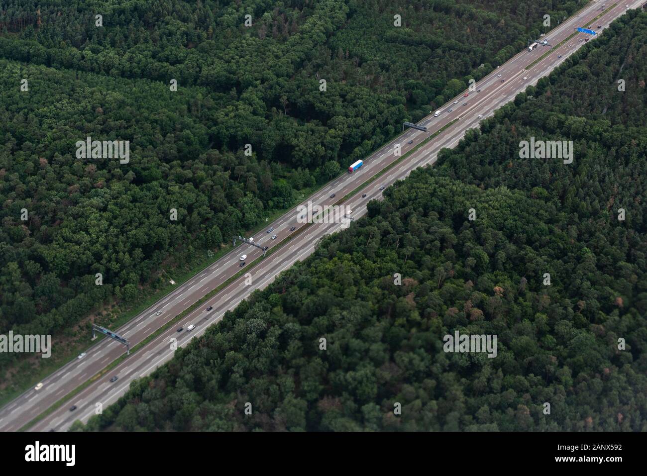 AERIAL, TOP DOWN: Cars and trucks drive on a highway speed road. Flying ...