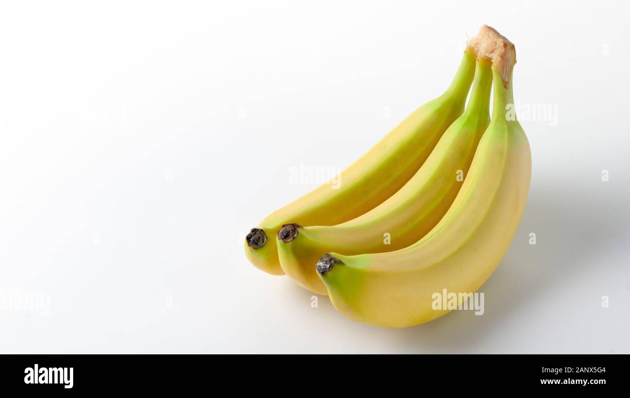 Three ripe little banana on a white background Stock Photo - Alamy