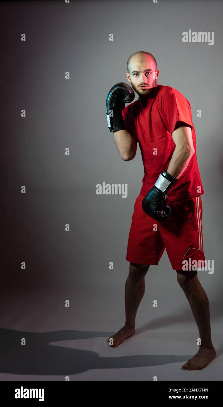 Muscular Fighter kickbox With Red Bandages against the background of a ...