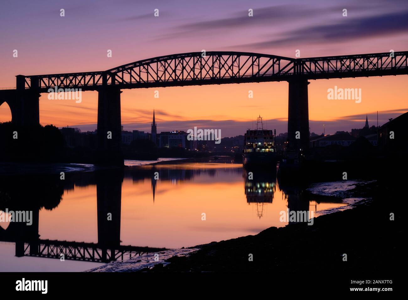 Skyline of Drogheda with night lights through the Boyne Viaduct seen ...