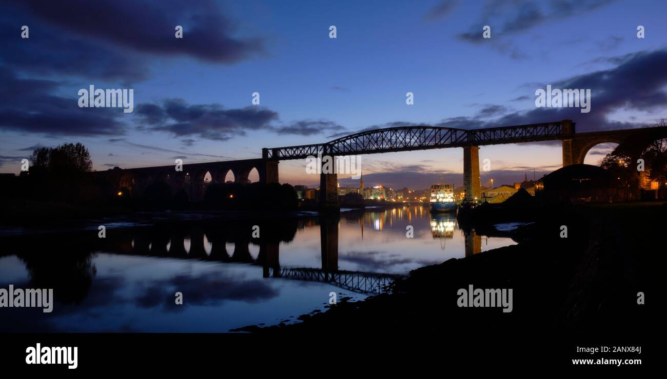 Skyline of Drogheda with night lights through the Boyne Viaduct seen ...