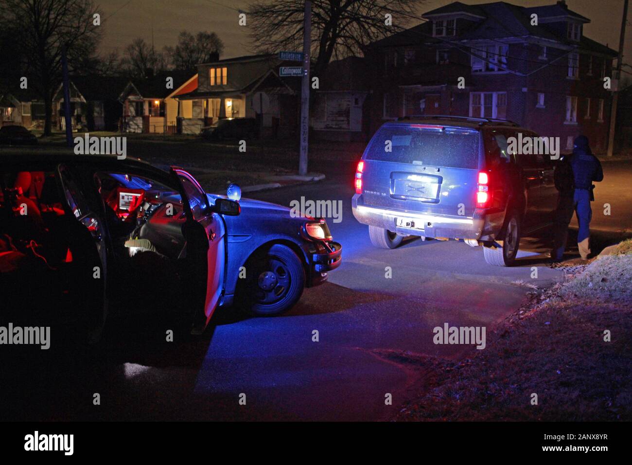 Detroit police Special Ops officers stop a vehicle at night and speak ...
