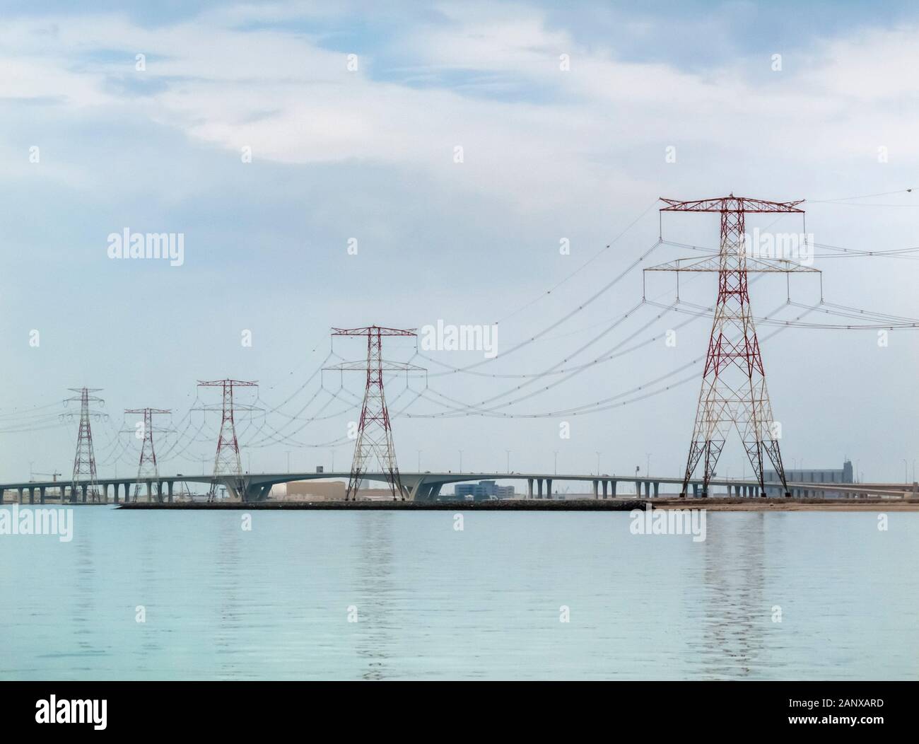 Red and white overhead electricity power lines and cables crossing ...