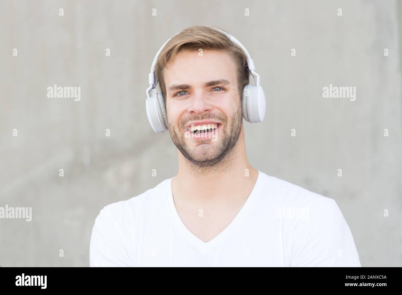 Music makes my day. Happy man listen to music grey background. Handsome ...