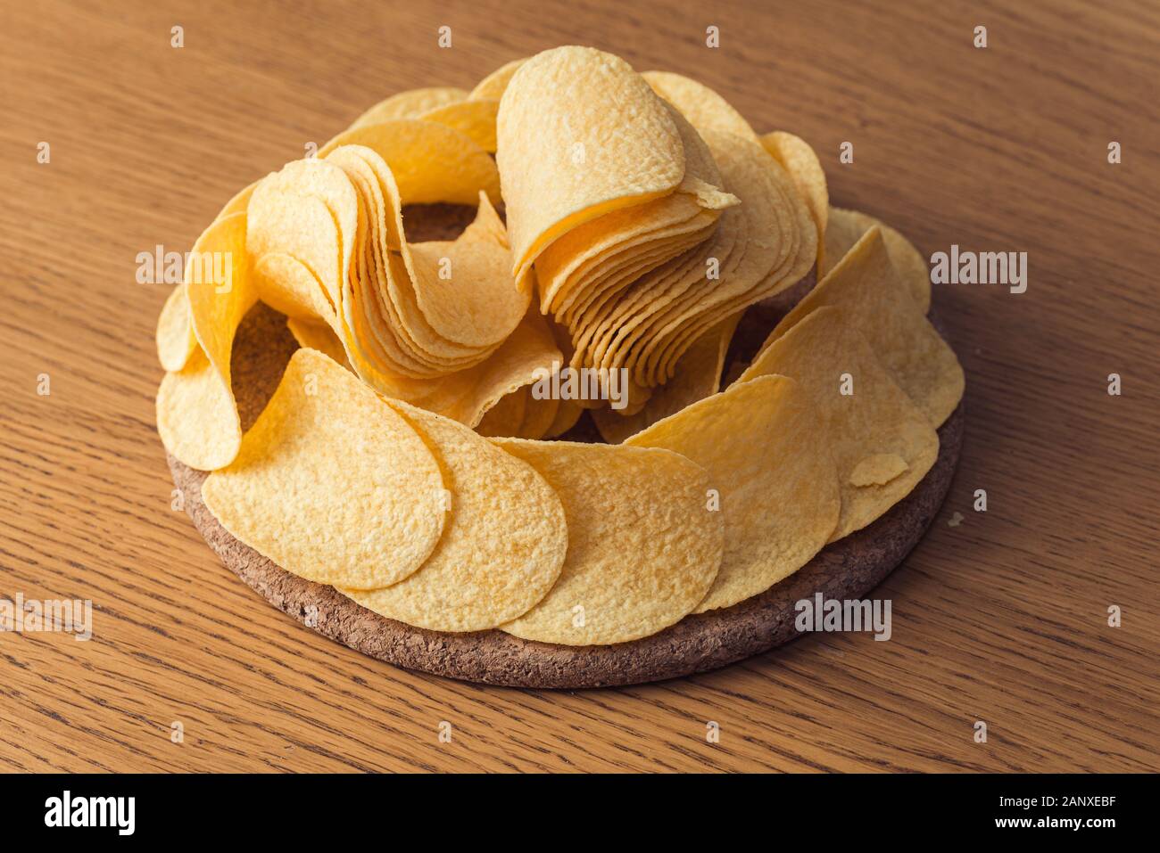 Delicious potato chips, laying on wooden table background Stock Photo ...