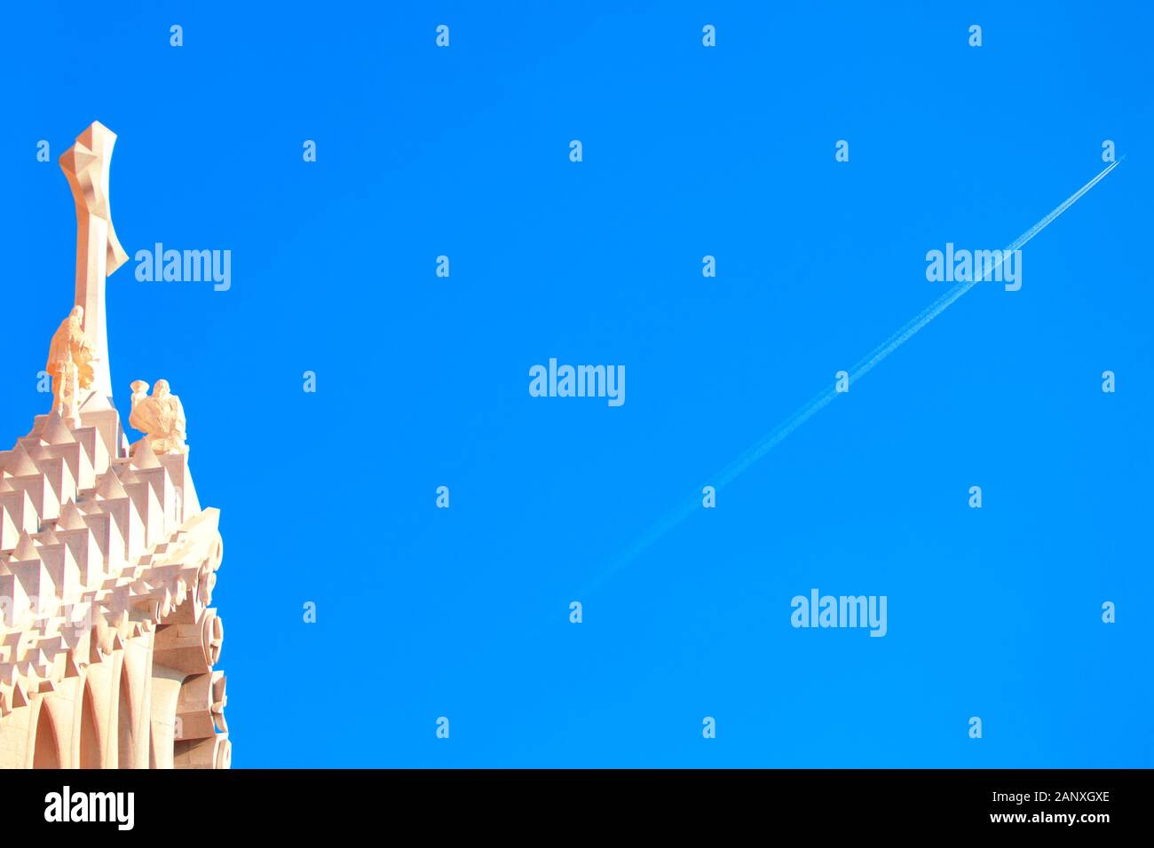 white cross on the church top and trace of an airplane on the blue sky ...