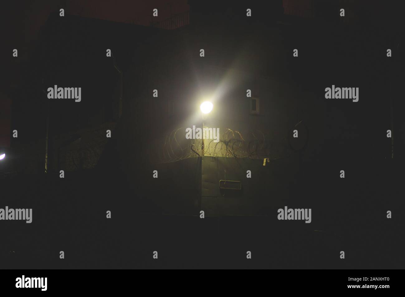 A night view of protected creepy penitentiary prison building facility ...