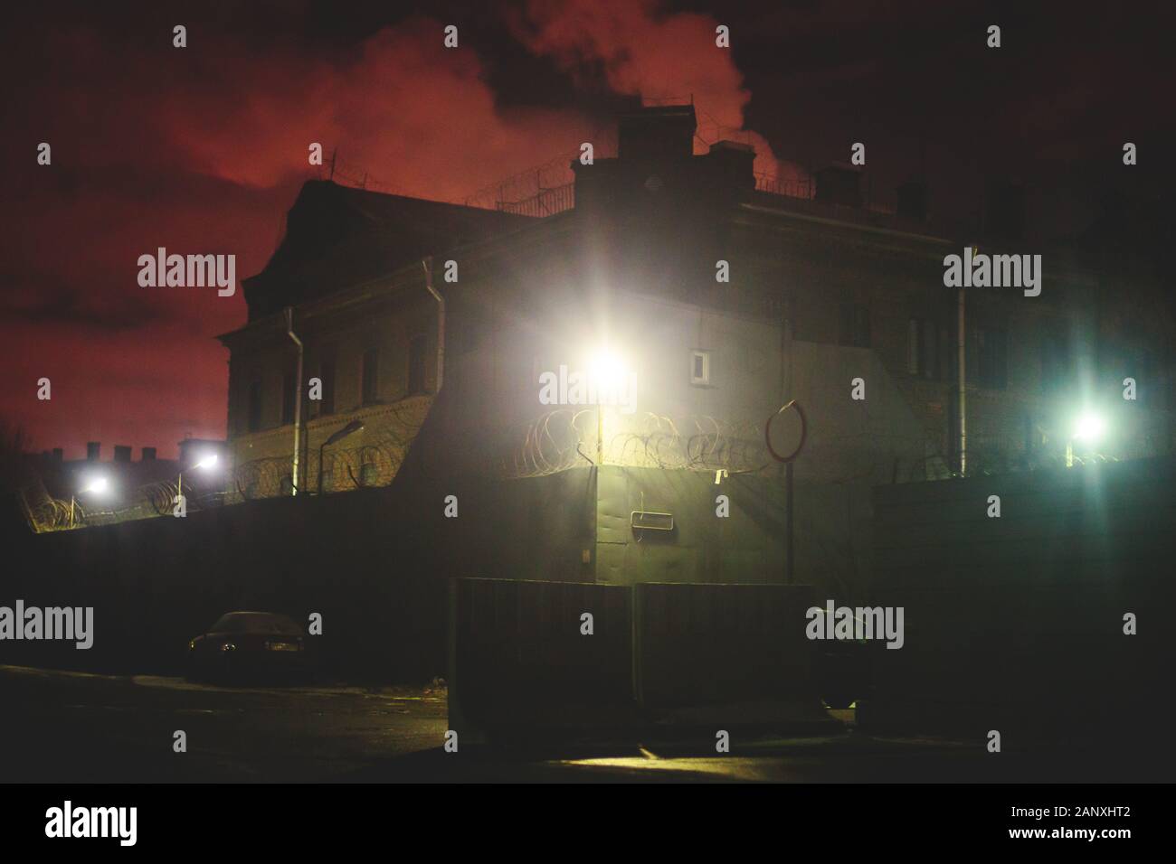 A night view of protected creepy penitentiary prison building facility ...