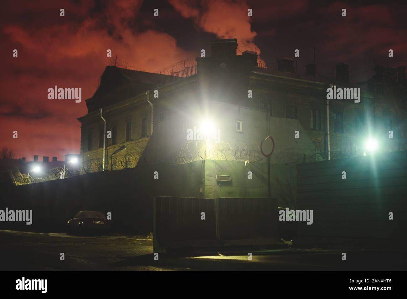 A night view of protected creepy penitentiary prison building facility ...