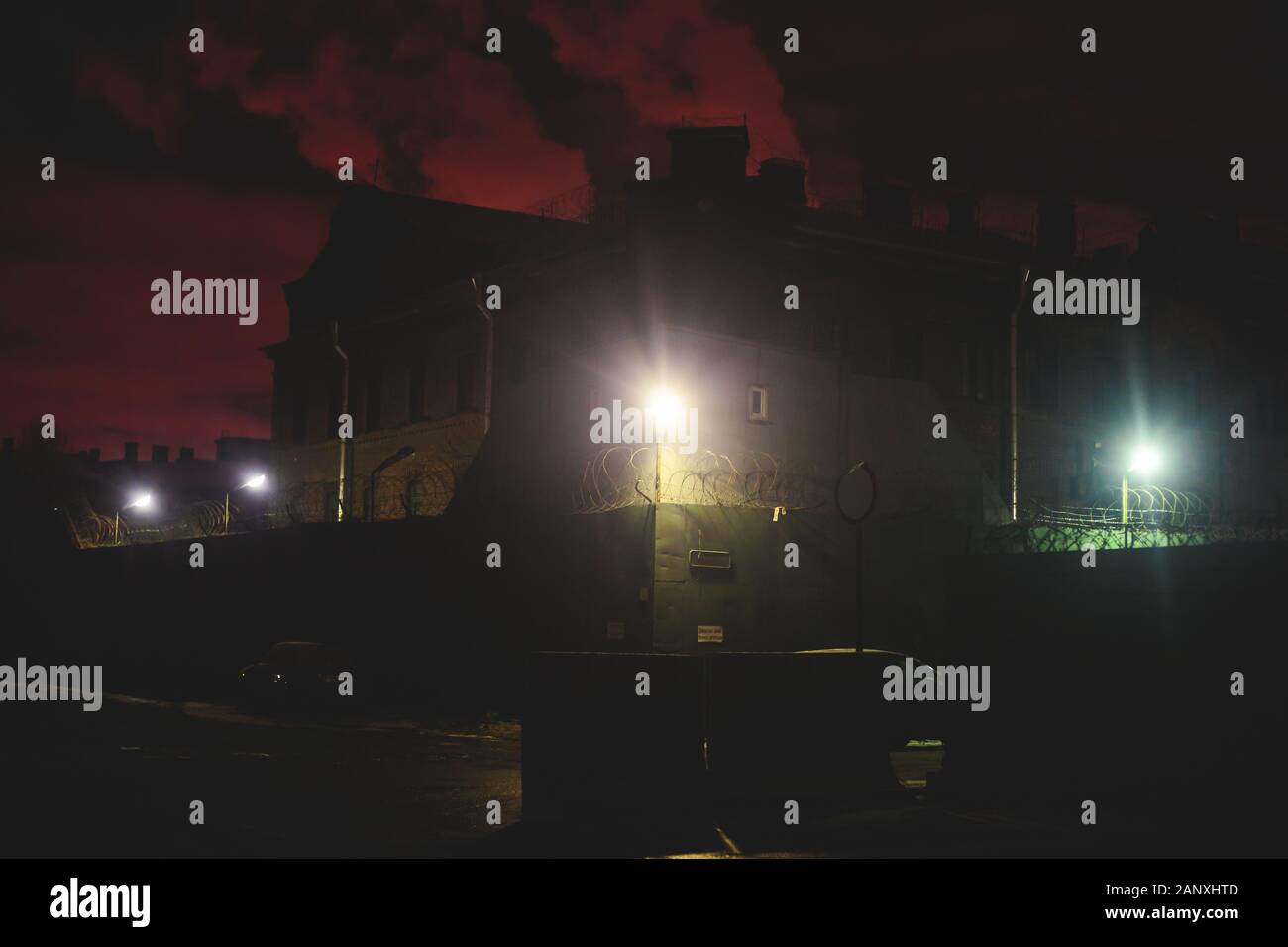 A night view of protected creepy penitentiary prison building facility ...