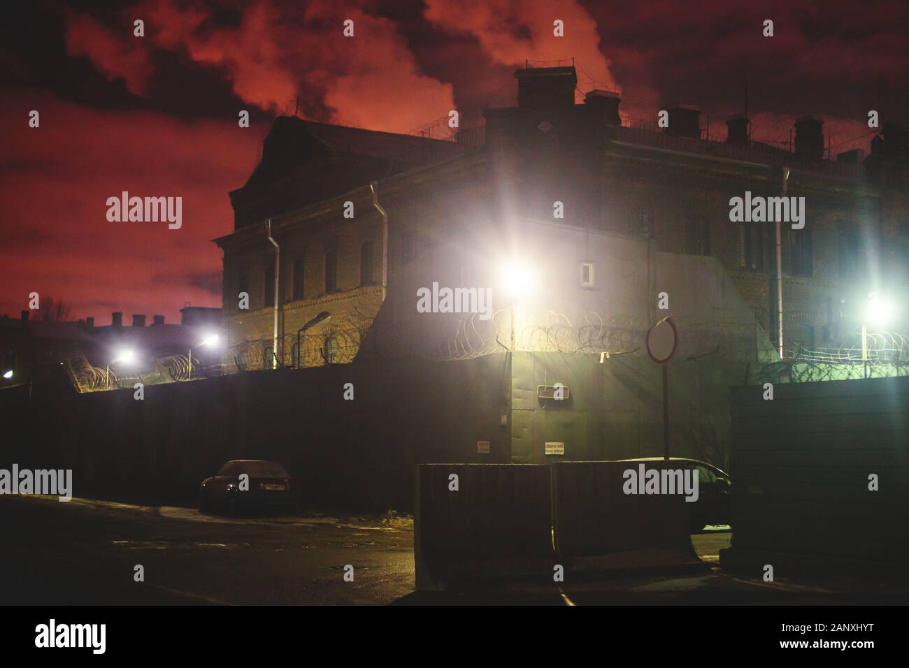 A night view of protected creepy penitentiary prison building facility ...