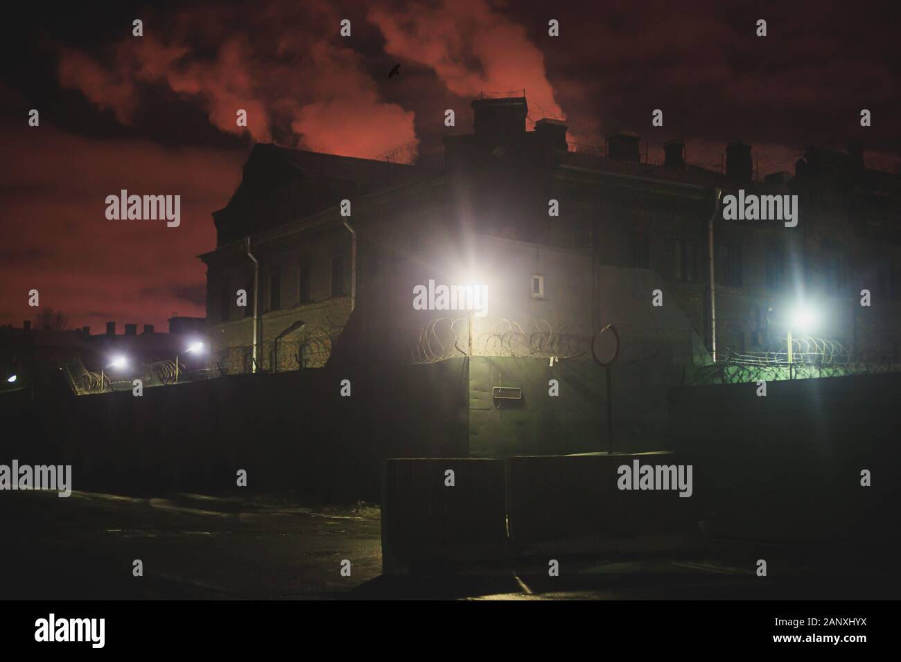 A night view of protected creepy penitentiary prison building facility ...