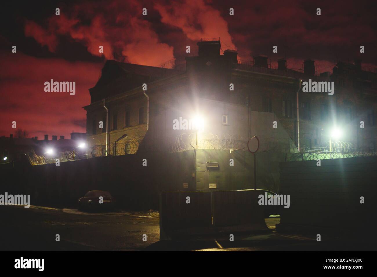 A night view of protected creepy penitentiary prison building facility ...
