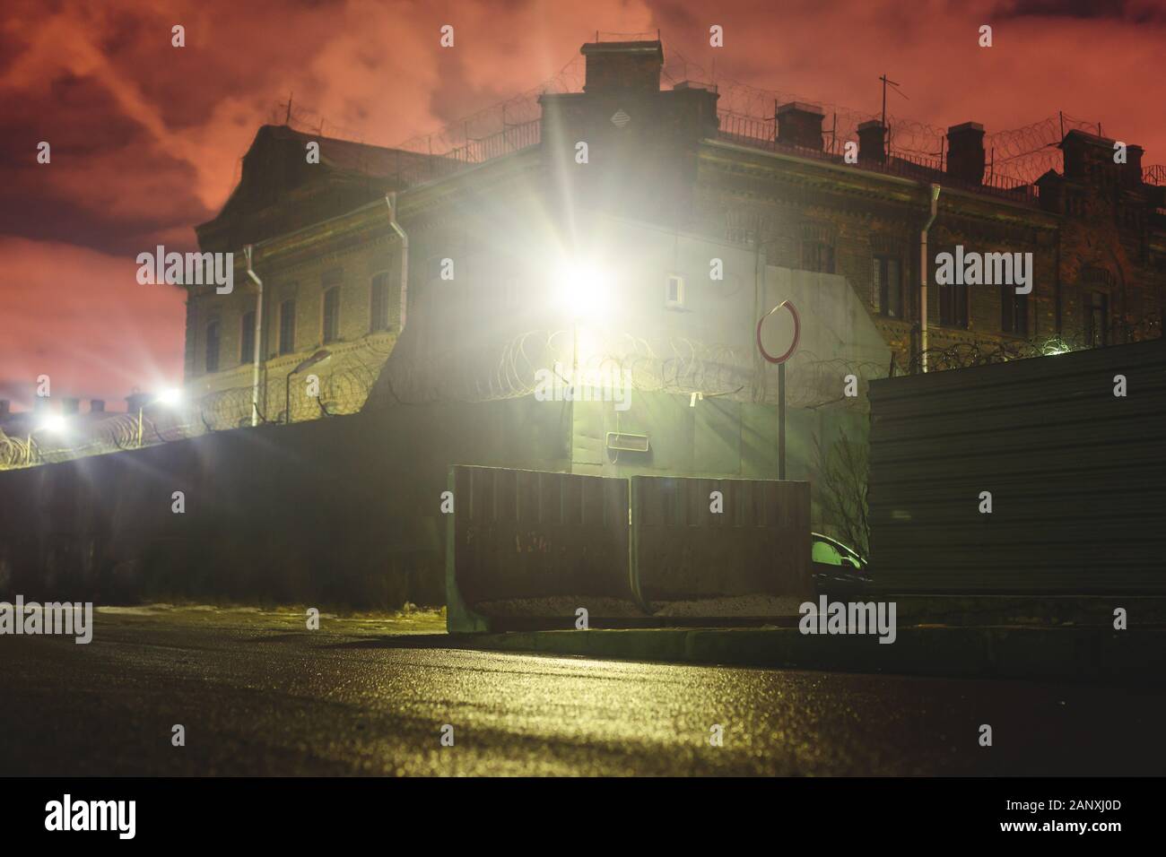 A night view of protected creepy penitentiary prison building facility ...