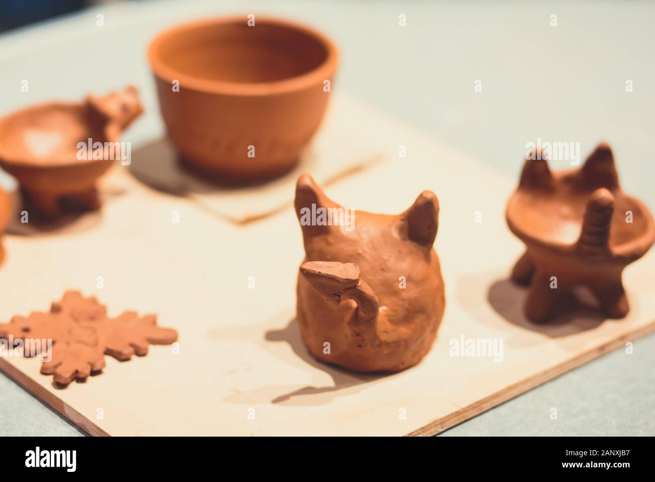 A process of pottery, with two people involved, working on pottery ...