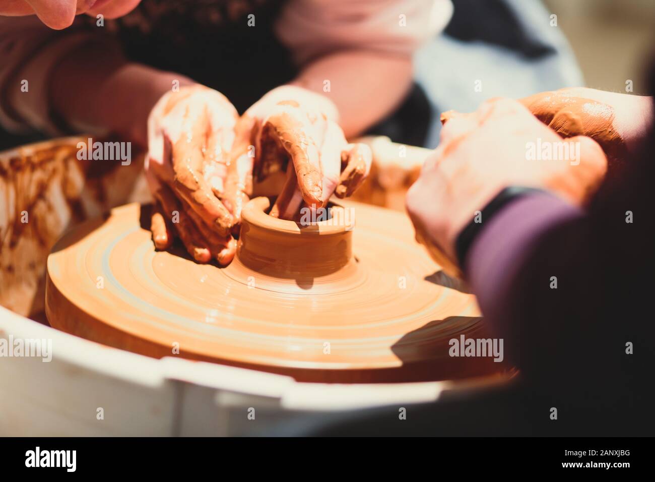 A process of pottery, with two people involved, working on pottery ...