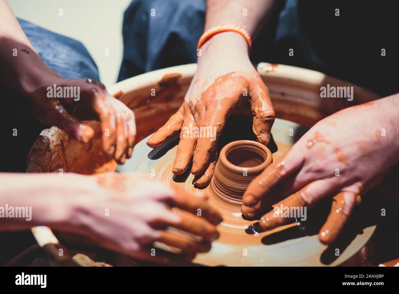 A process of pottery, with two people involved, working on pottery ...