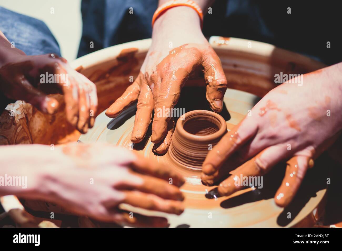 A process of pottery, with two people involved, working on pottery ...
