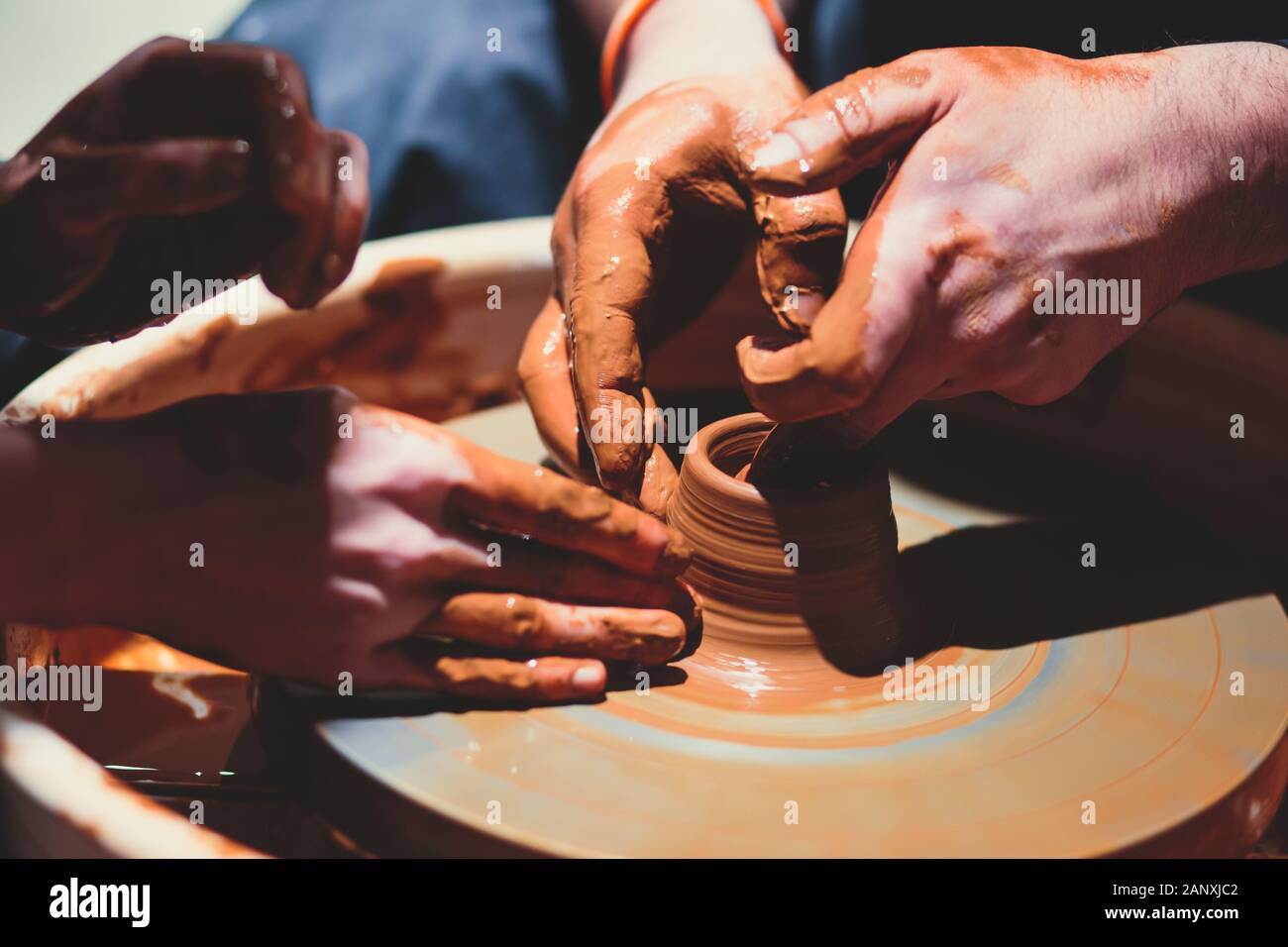 A process of pottery, with two people involved, working on pottery ...