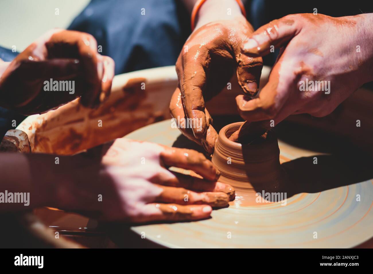 A process of pottery, with two people involved, working on pottery ...