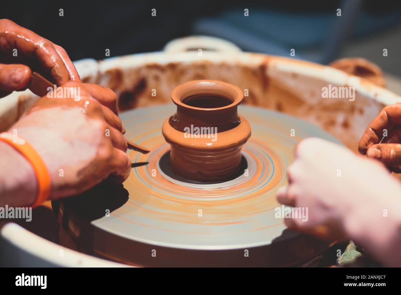 A process of pottery, with two people involved, working on pottery ...