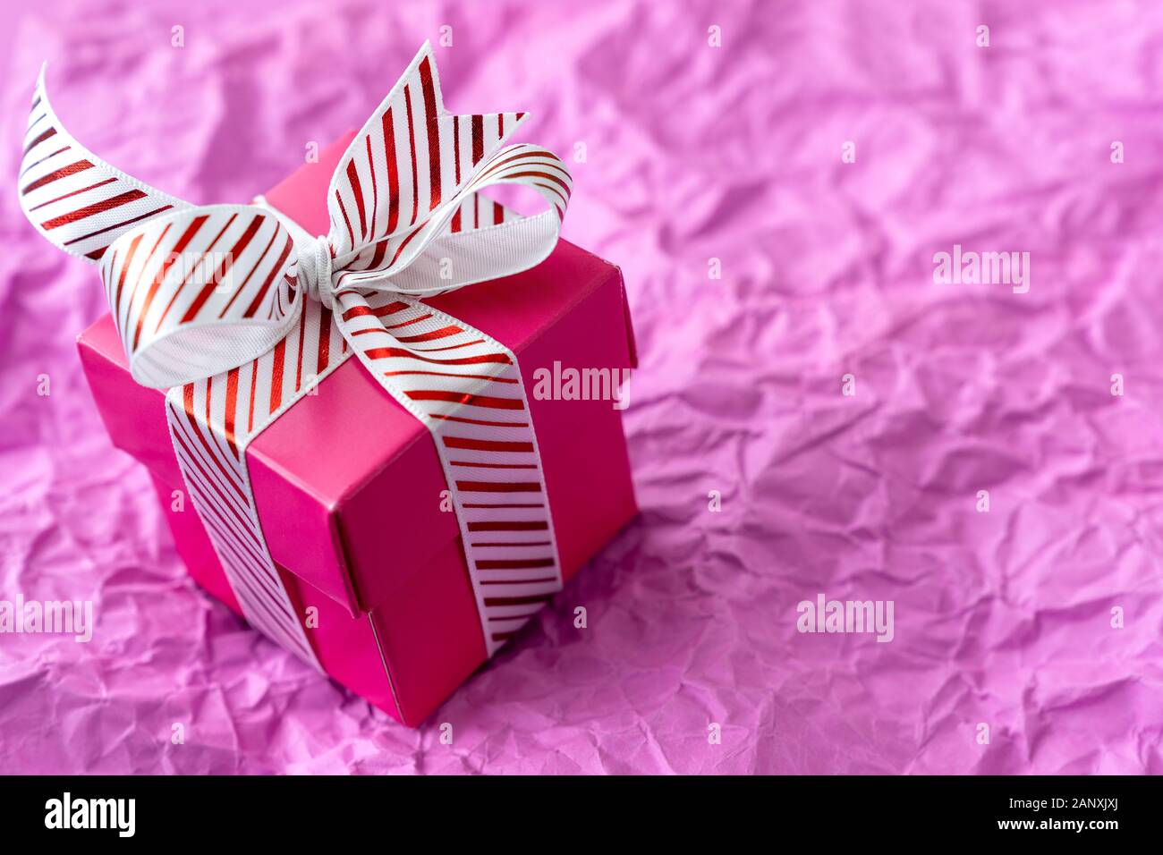 Pink present box on crumpled paper pink background Stock Photo - Alamy