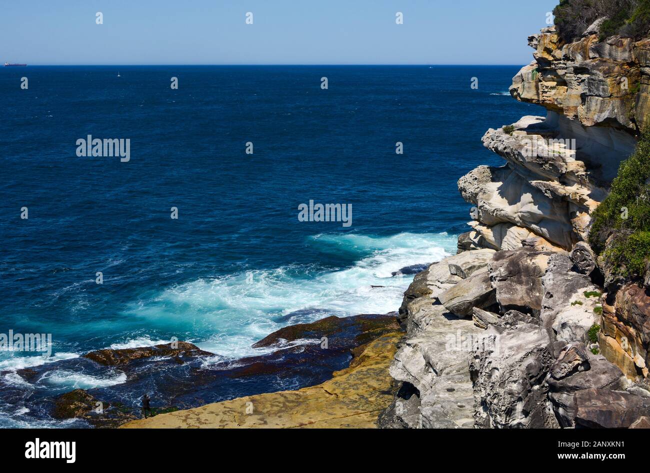 Rocky sandstone cliffs along the jagged coast of Lady Bay in South Head ...