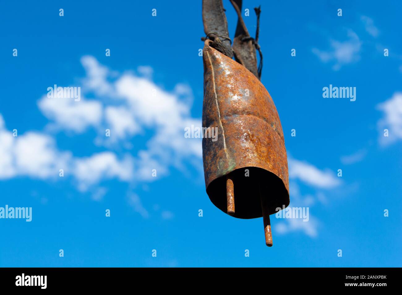 campane. obsolete rusted animal bell. blue sky background Stock Photo ...