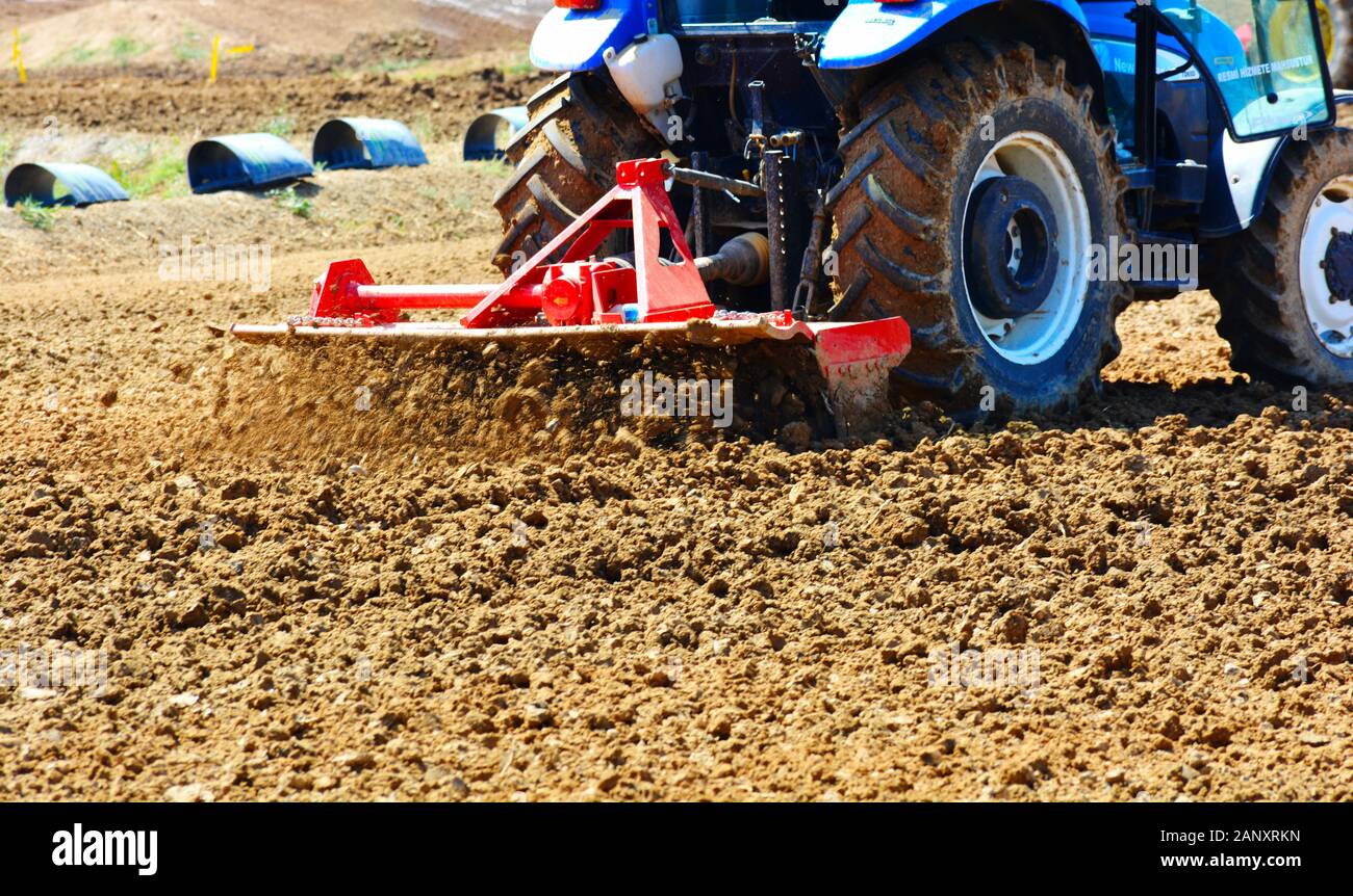 making field(garden) hoeing and tillage with tractor. sowing ...
