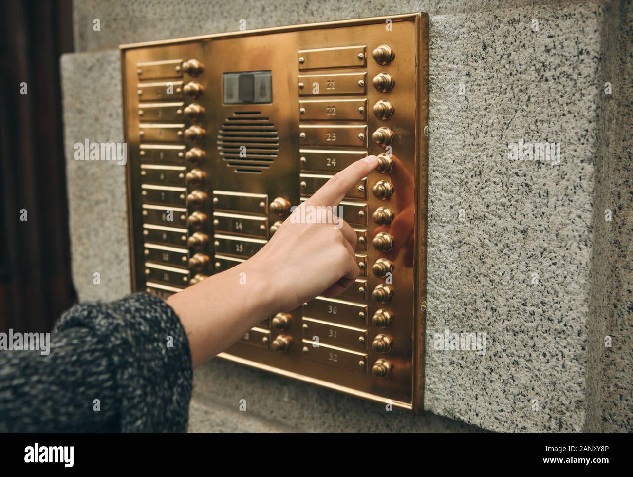 Female hand presses the intercom button to access inside Stock Photo ...
