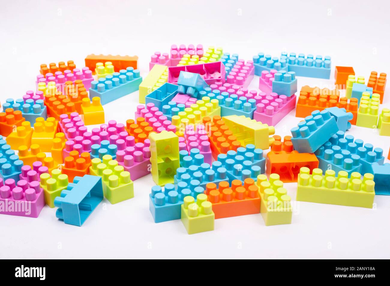 multi colored blocks of a children designer scattered on a white ...