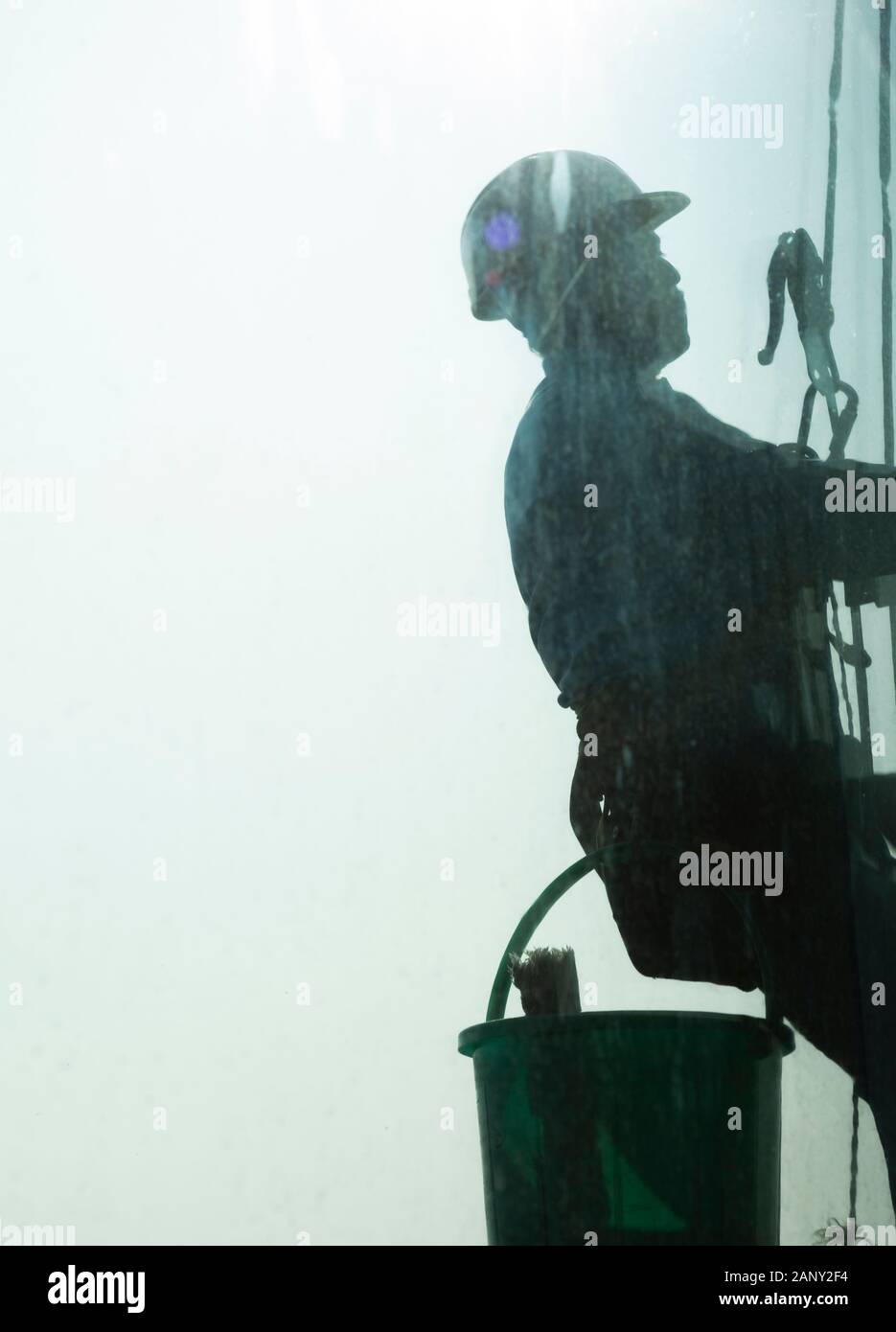 Silhouette of Window Cleaner with dirty window in foreground Stock ...