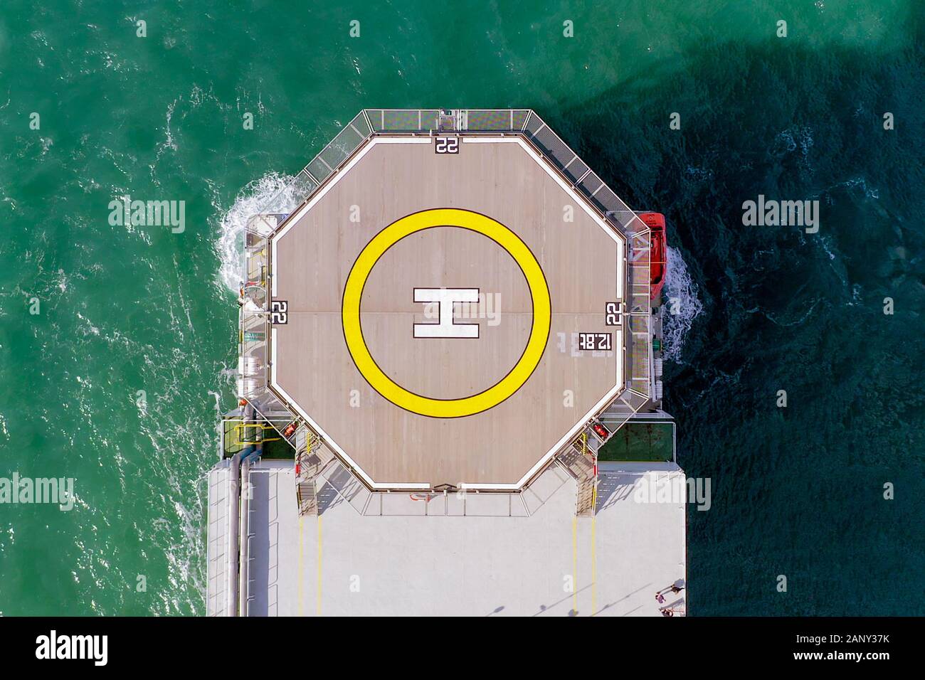 Large Red Cargo ship at sea with a Helipad, Top down aerial image Stock ...