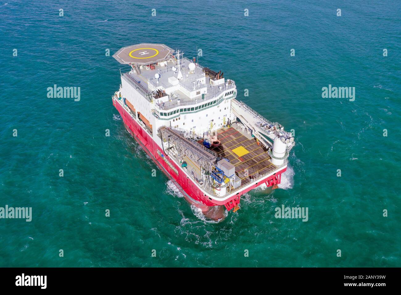 Large Platform supply ship with Helipad and two large cranes, anchored ...
