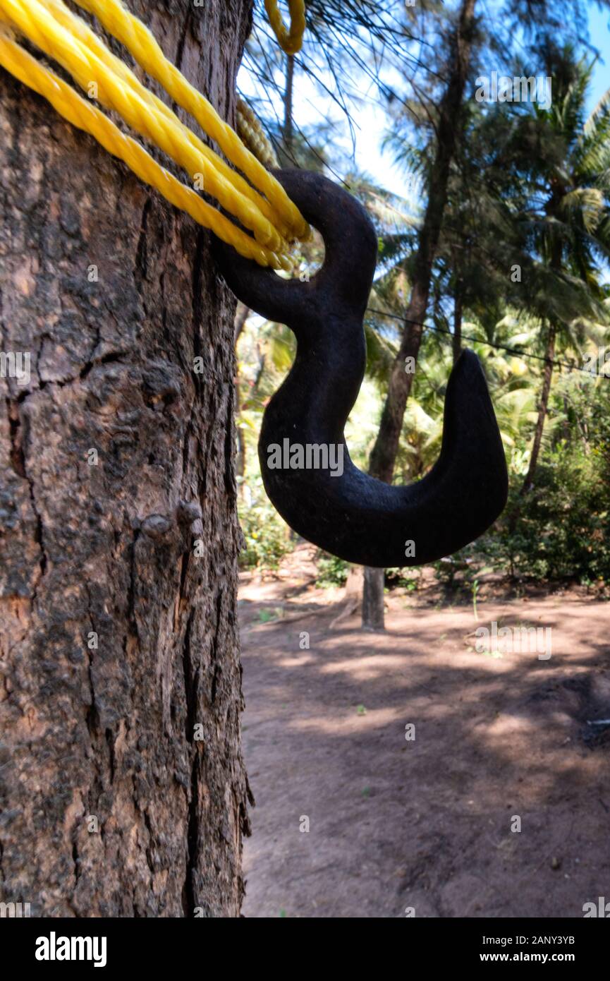 Metal hook tied on tree Stock Photo - Alamy