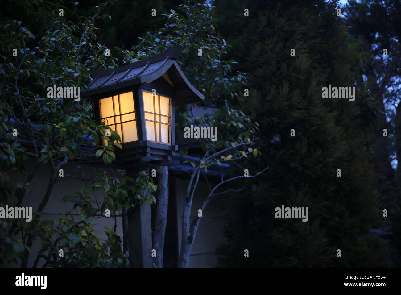Japanese style garden lamp. Japanese gable roof house light post in ...