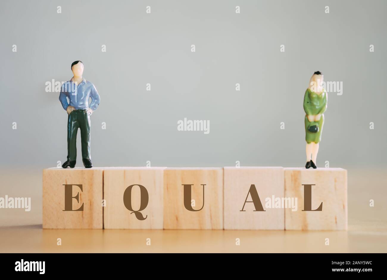 Gender equality concept, miniature males and female figurine stand on ...