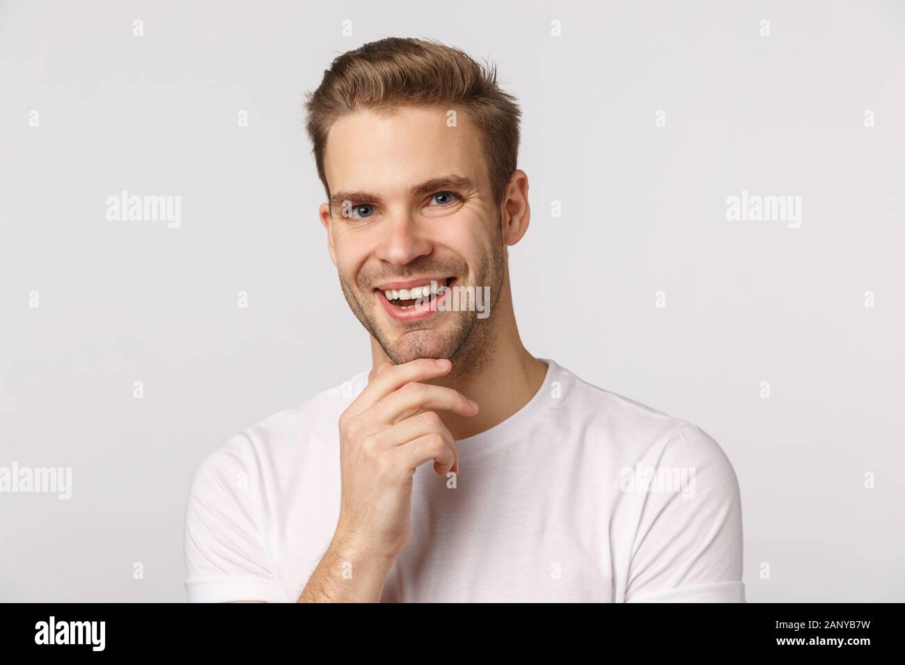 Very good. Intrigued and pleased thoughtful young man, smiling ...