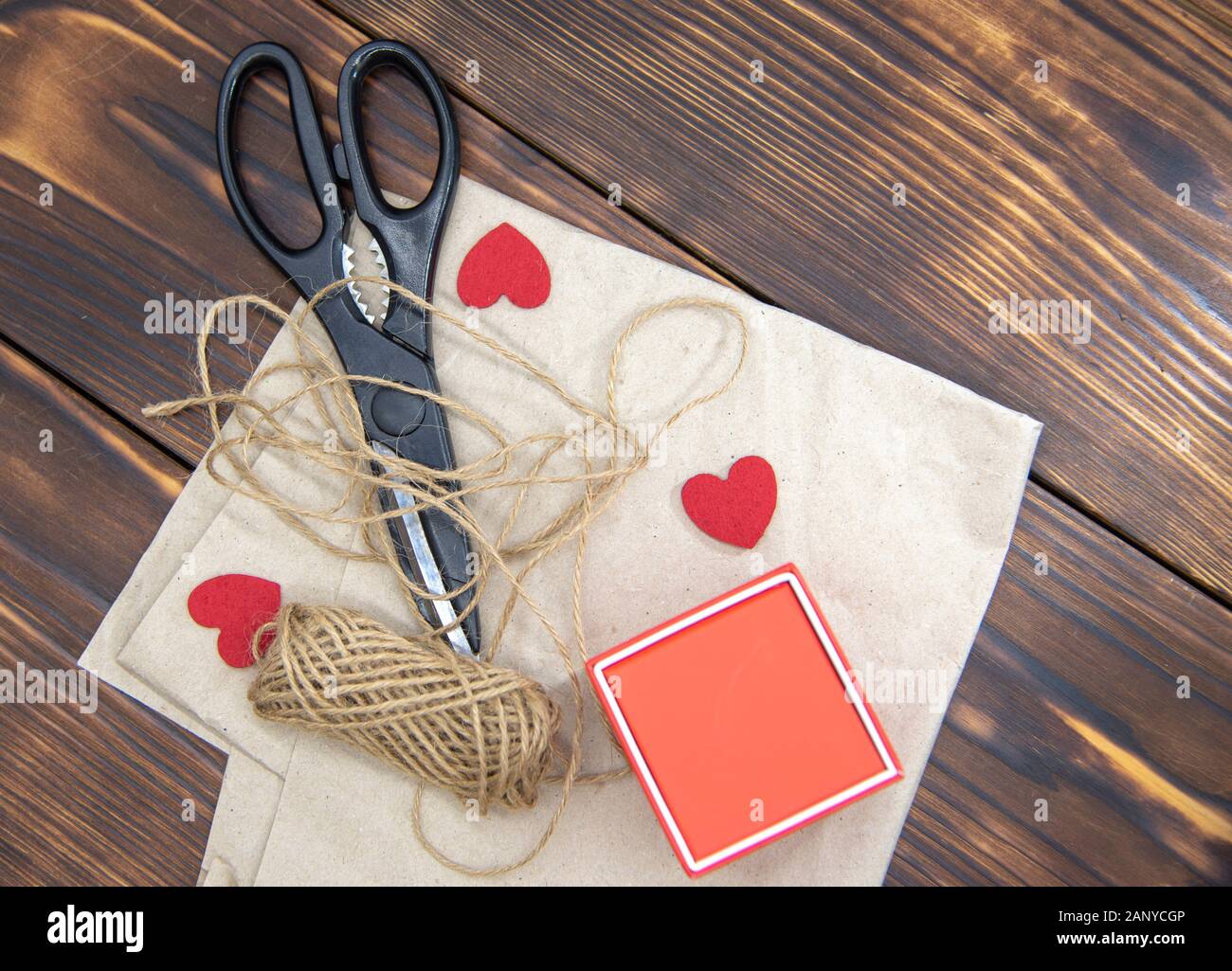 Scissors, coarse thread, and a gift box lie on Kraft paper Stock Photo ...