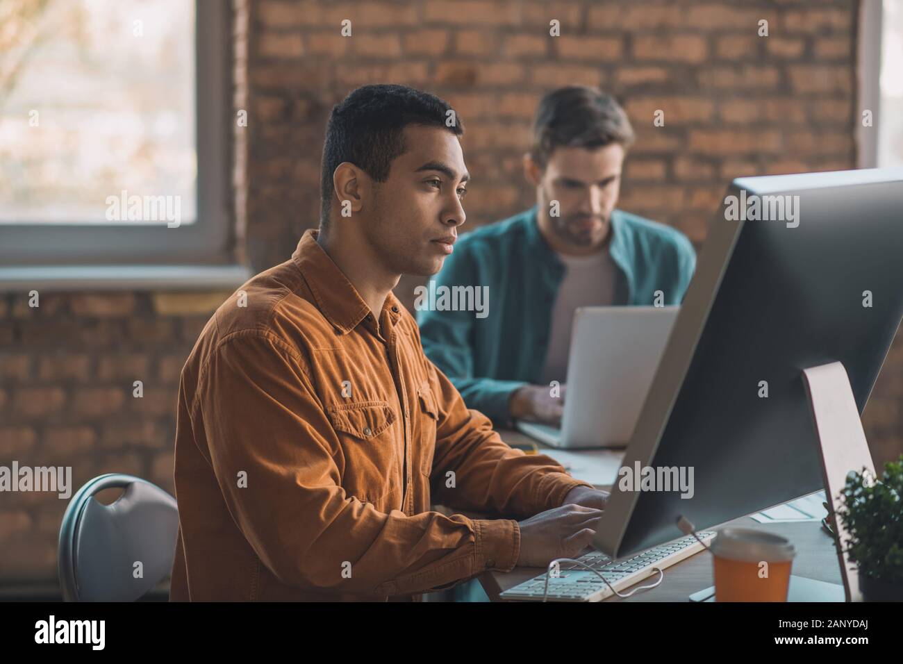 Handsome smart man looking at the computer screen Stock Photo - Alamy