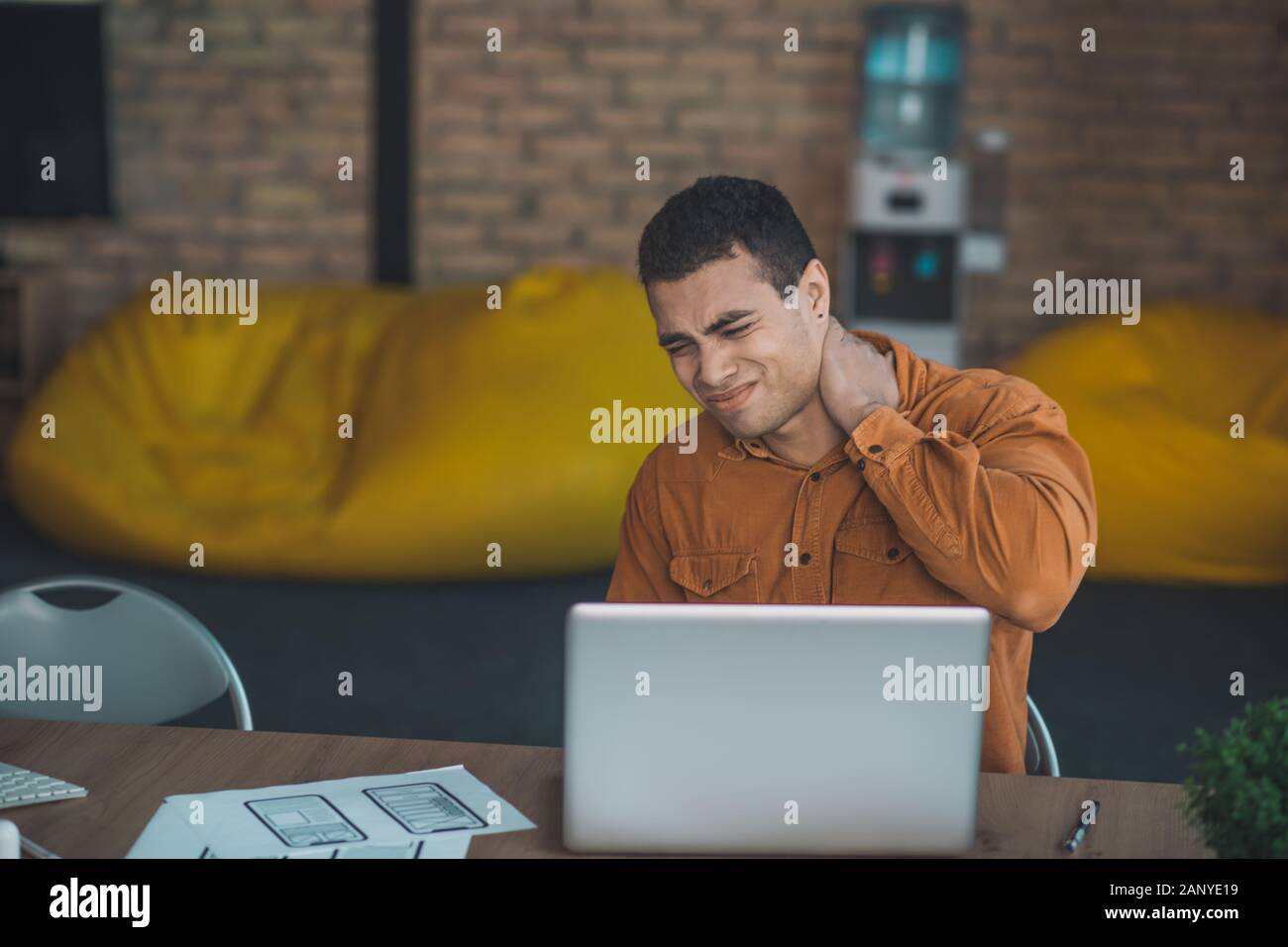 Nice brunette man putting his hand on the neck Stock Photo - Alamy