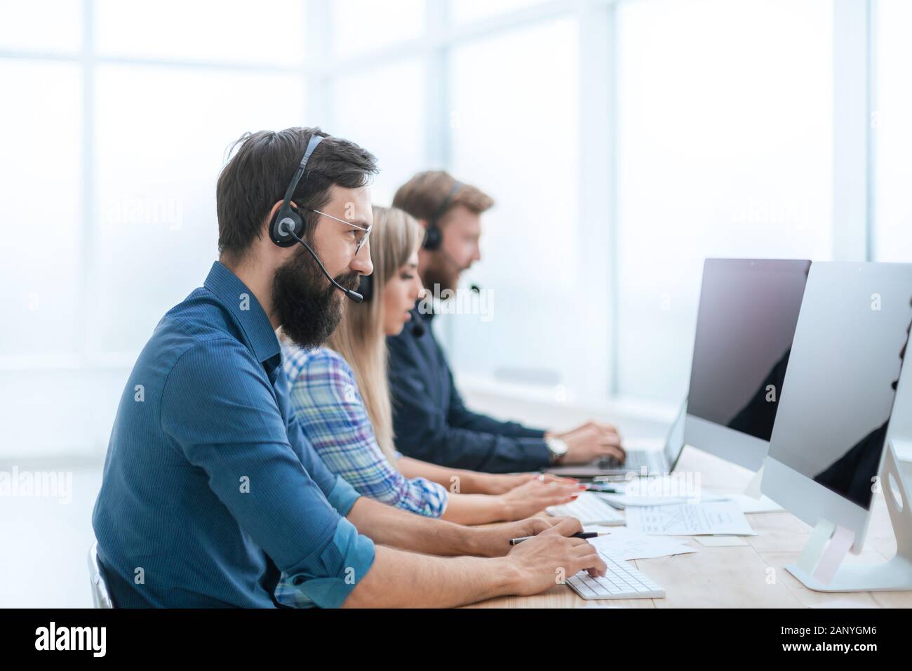 call center employees work on PC in the office Stock Photo - Alamy