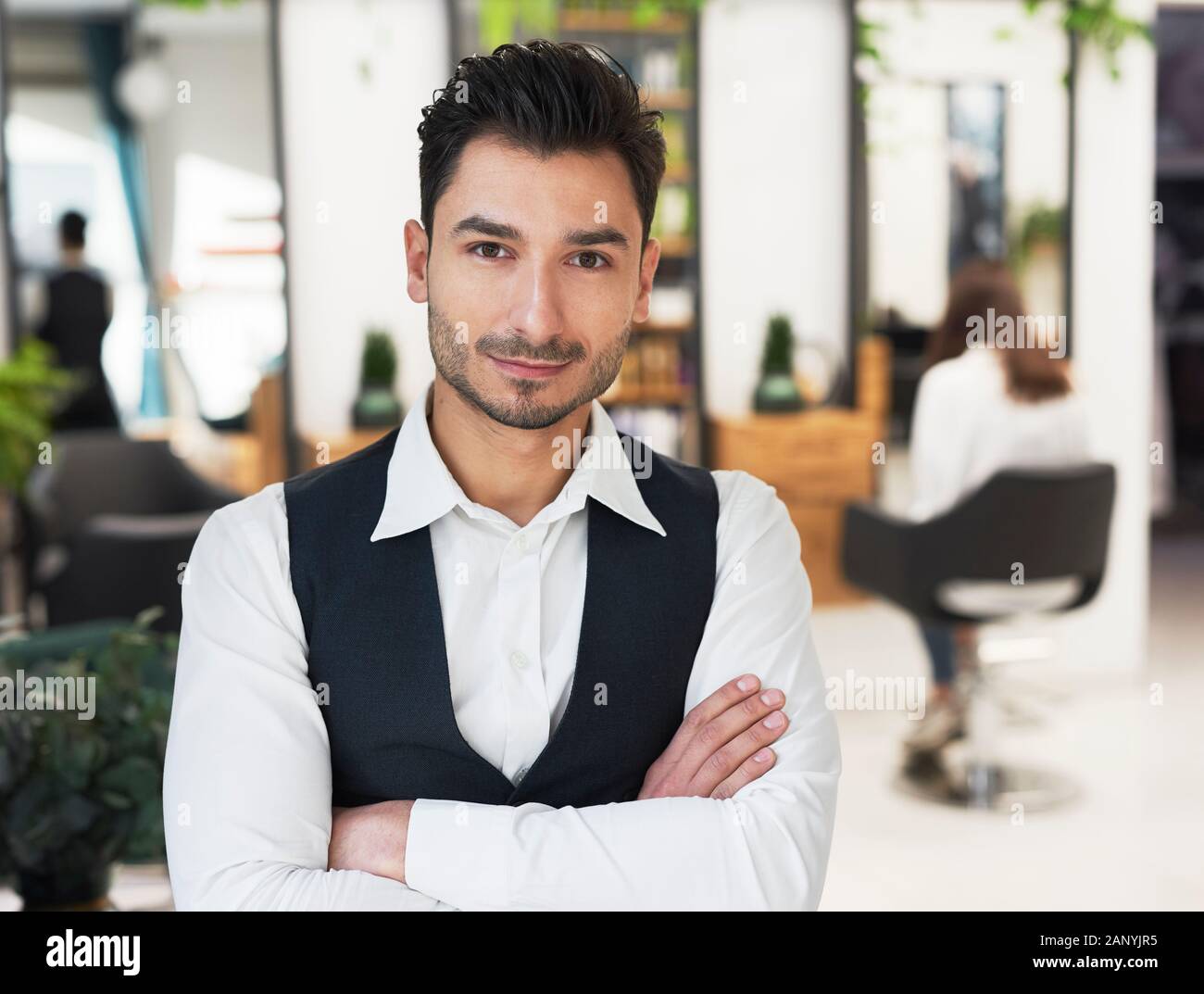 Smiling owner of hairdresser salon Stock Photo - Alamy