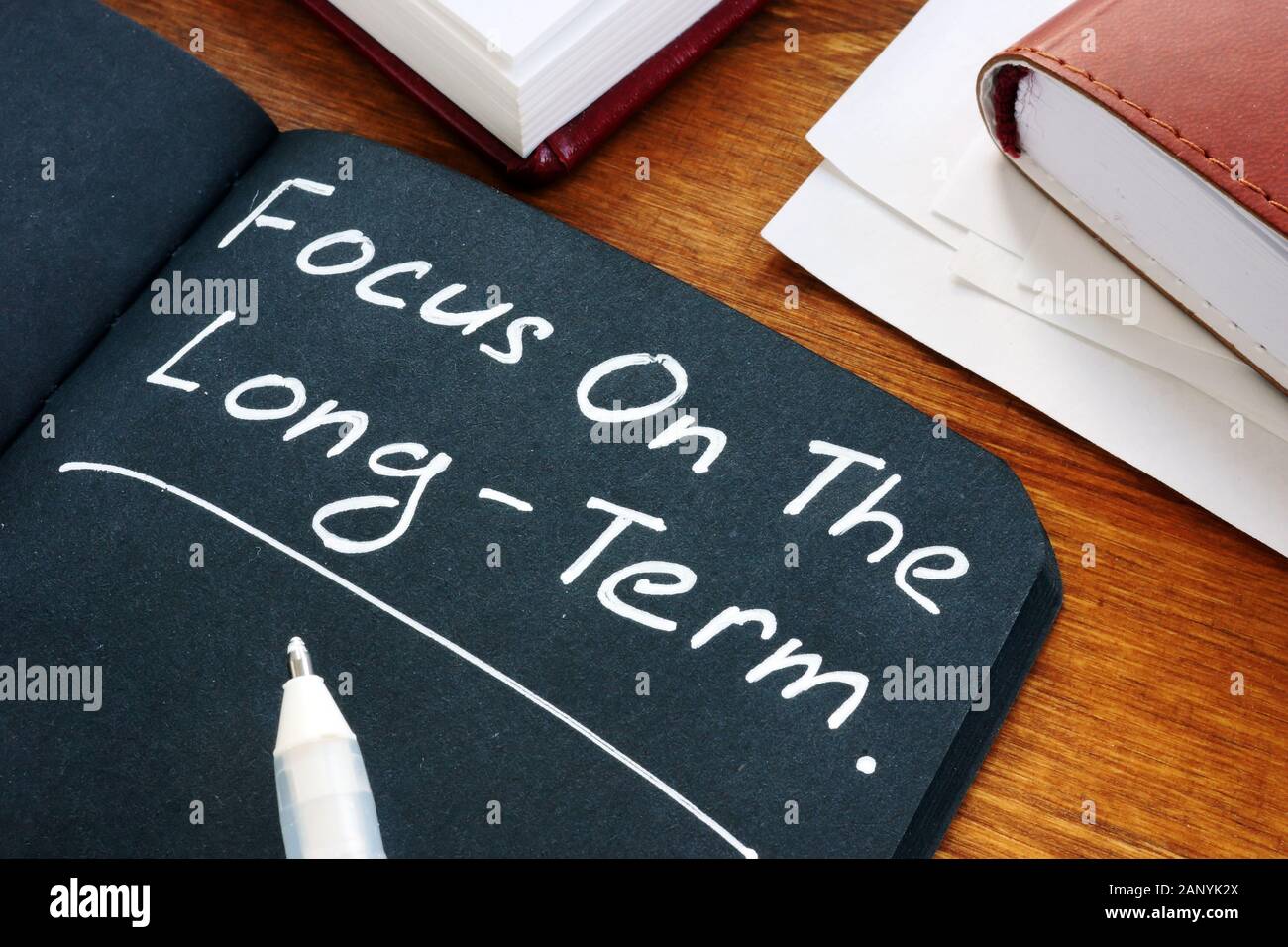Focus on the long term written on the black page Stock Photo - Alamy