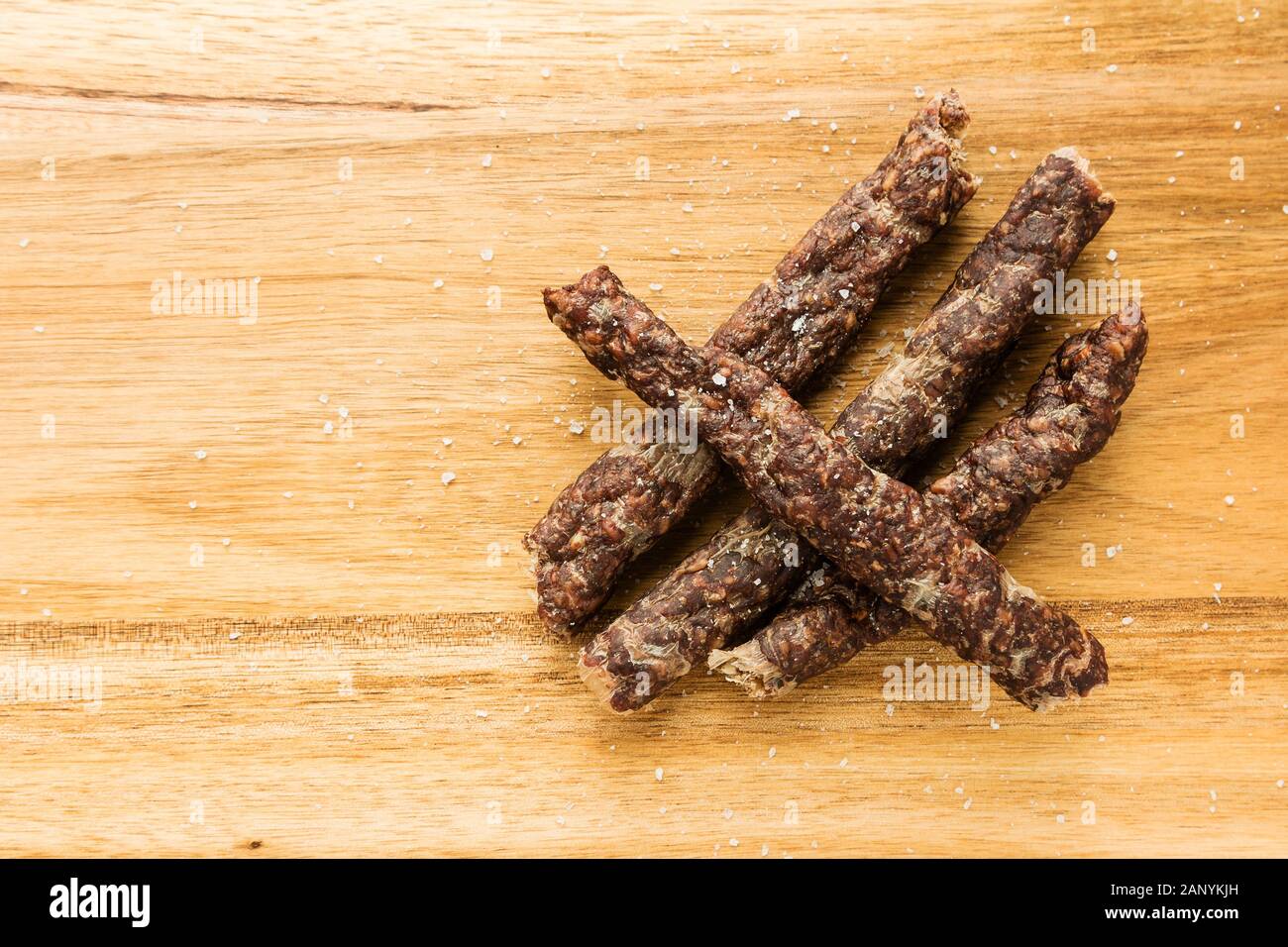 Couple of sticks of droewors on a wooden surface - popular South ...
