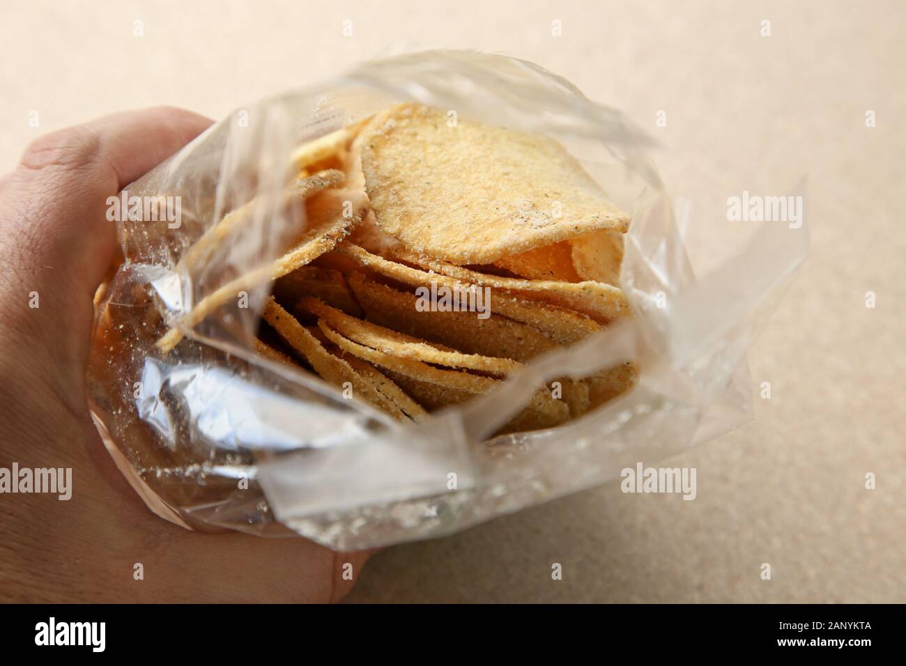 Plastic bag of unhealthy potato chips - junk food concept Stock Photo ...