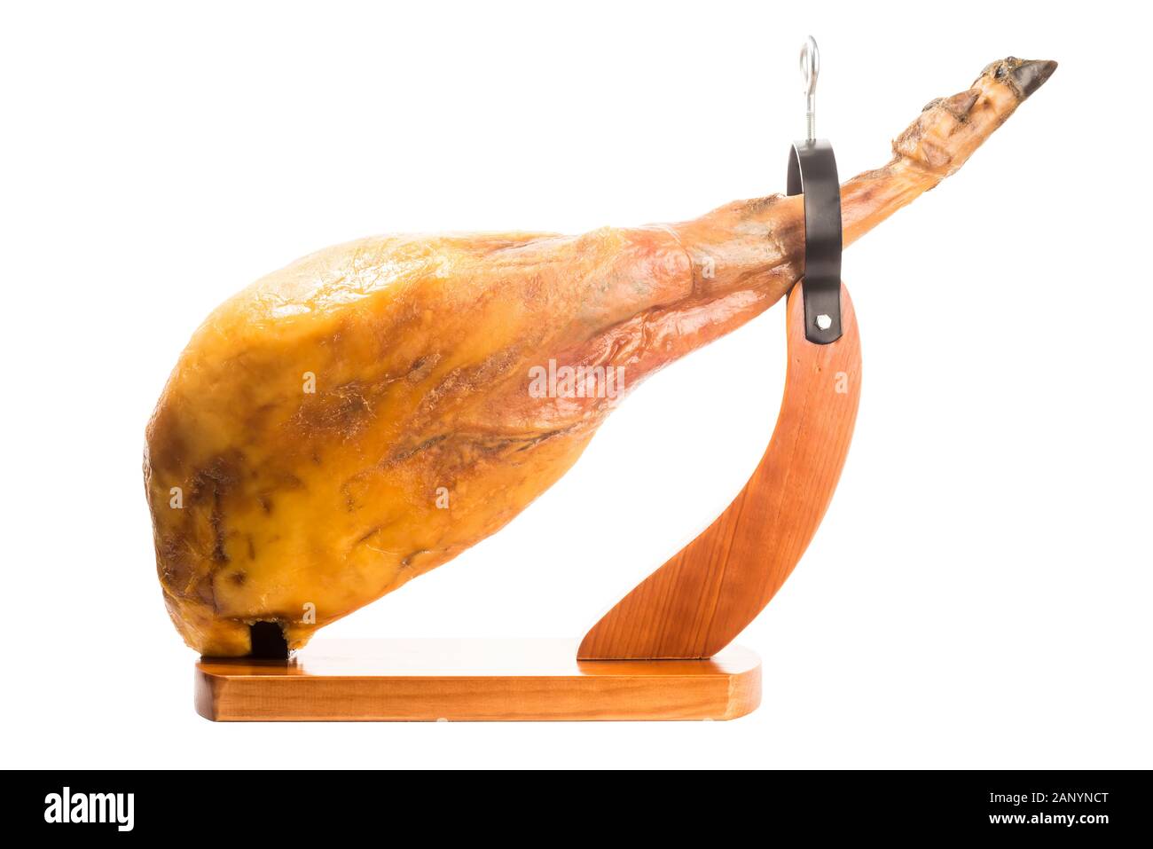 Whole Iberian ham leg spanish in a wooden ham stand isolated on white ...