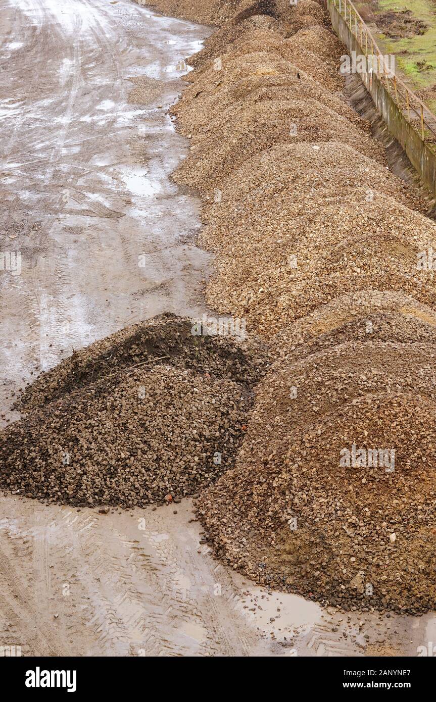 Vertical high angle shot of piles of sand in an area of construction ...
